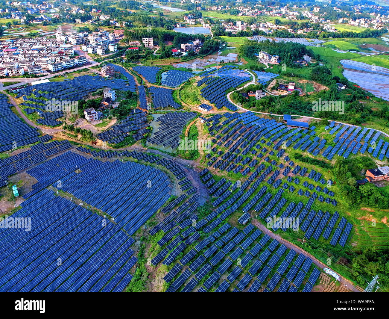 --FILE--Aerial view of arrays of solar panels installed around the ...