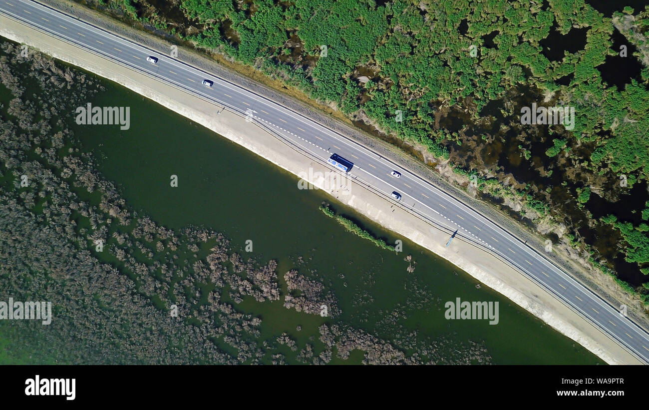 Aerial view of a highway around the Bosten Lake, one of the largest ...