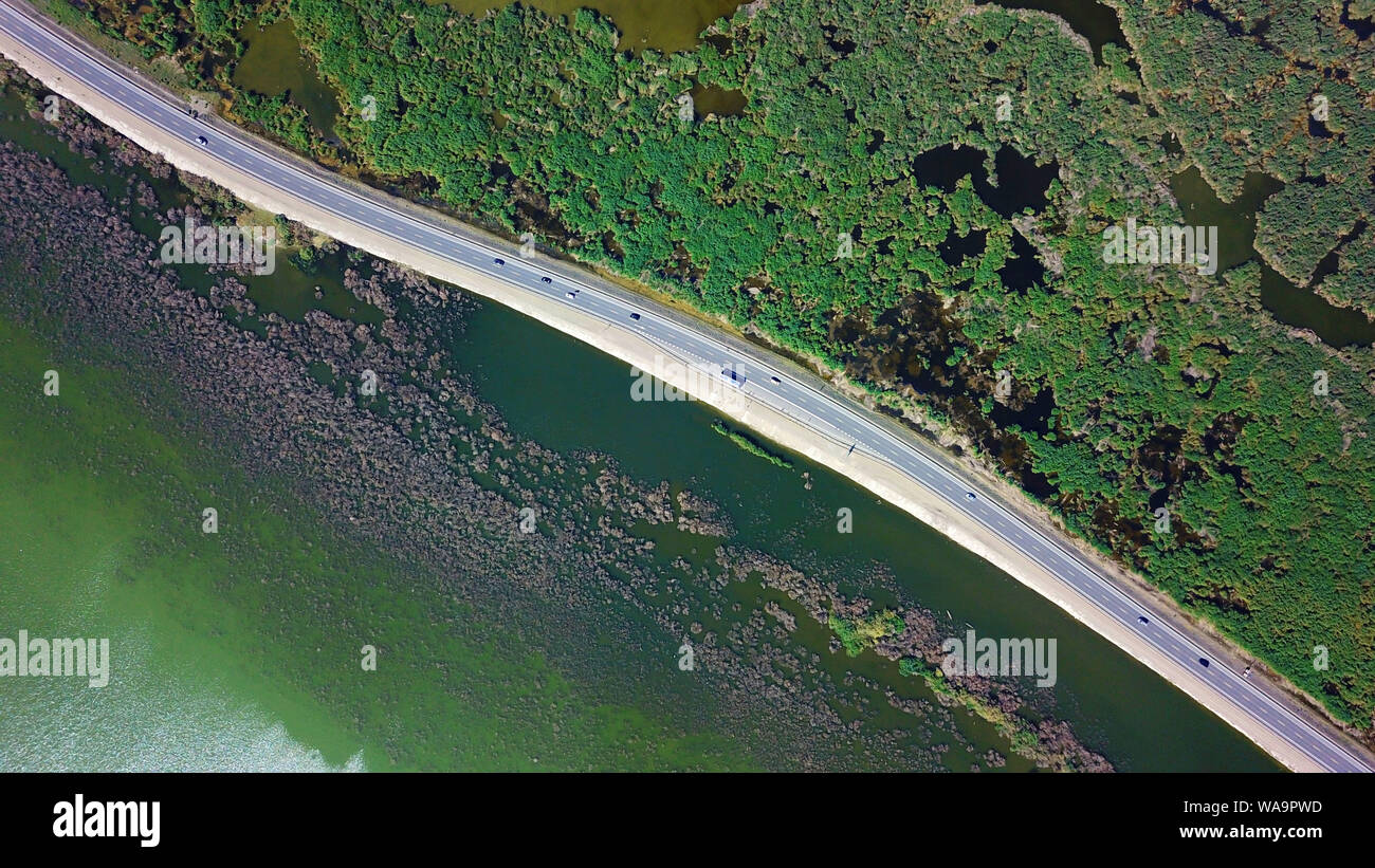 Aerial view of a highway around the Bosten Lake, one of the largest ...