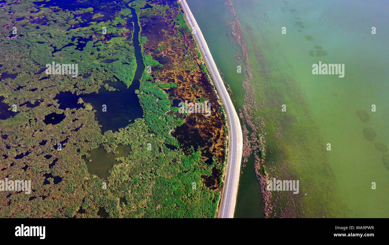 Aerial view of a highway around the Bosten Lake, one of the largest ...