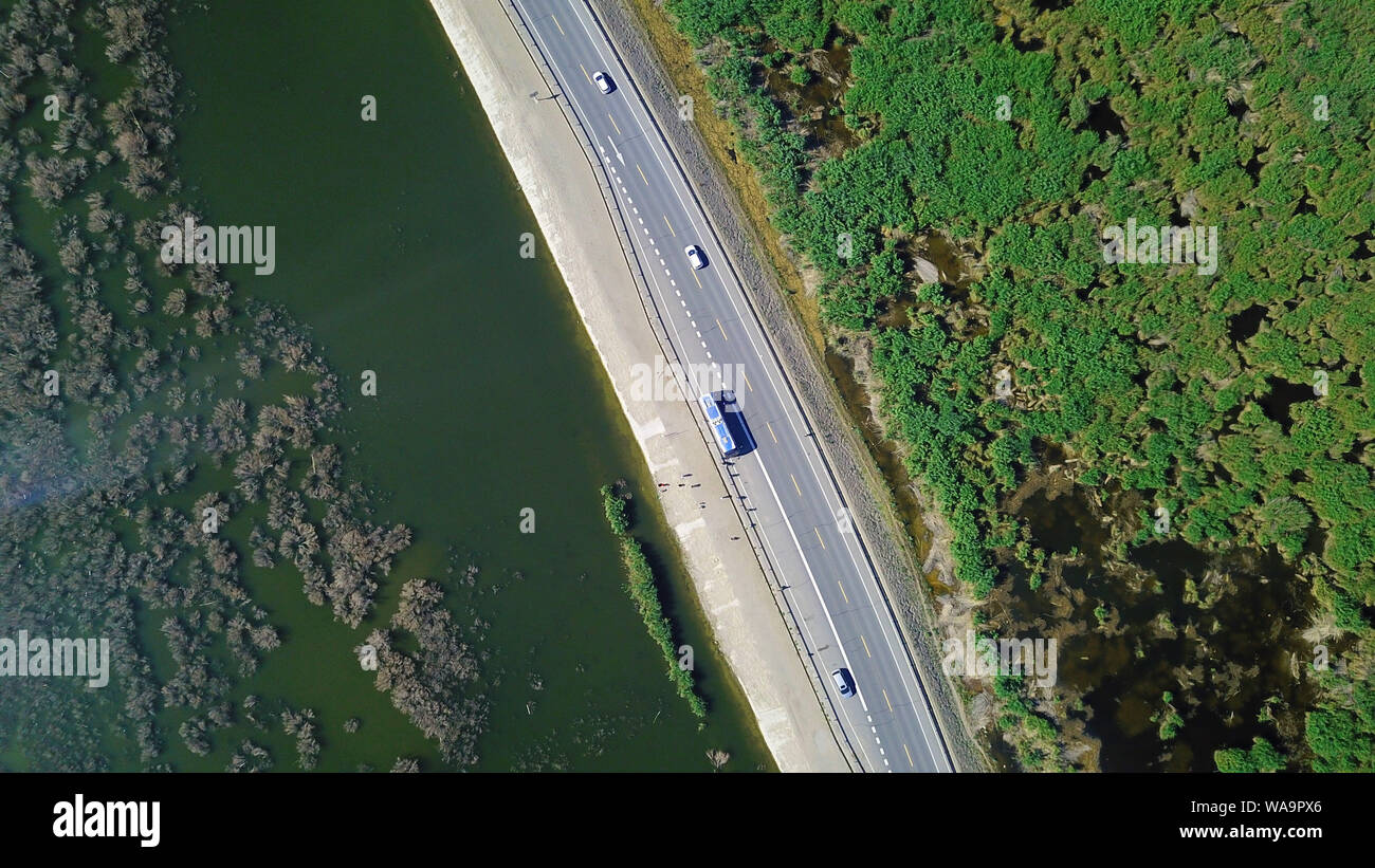 Aerial view of a highway around the Bosten Lake, one of the largest ...