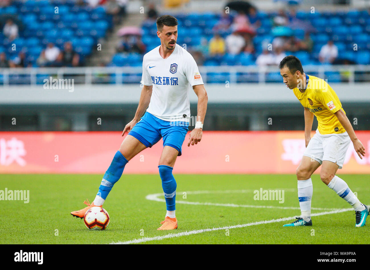 German football player Sandro Wagner, left, of Tianjin TEDA passes the ...