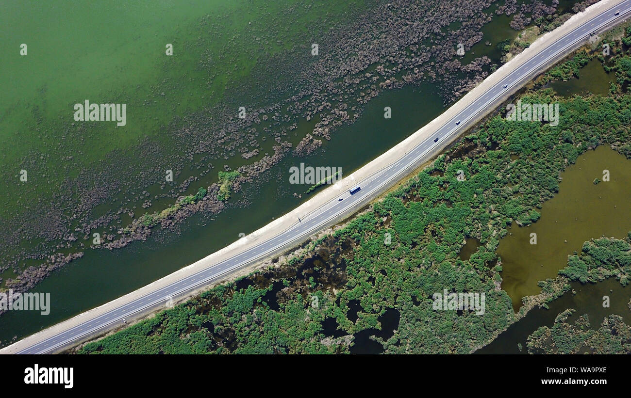 Aerial view of a highway around the Bosten Lake, one of the largest ...