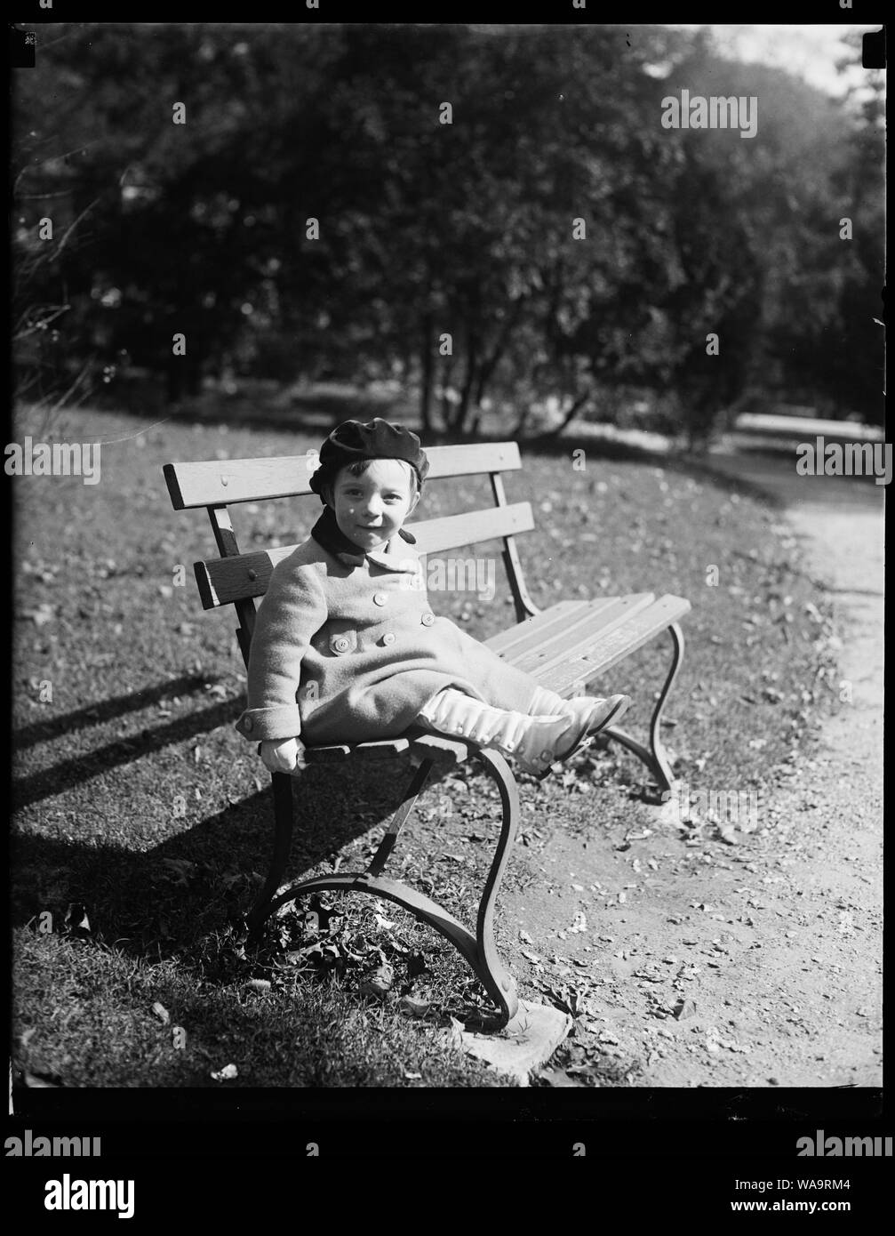 Child on park bench Stock Photo - Alamy