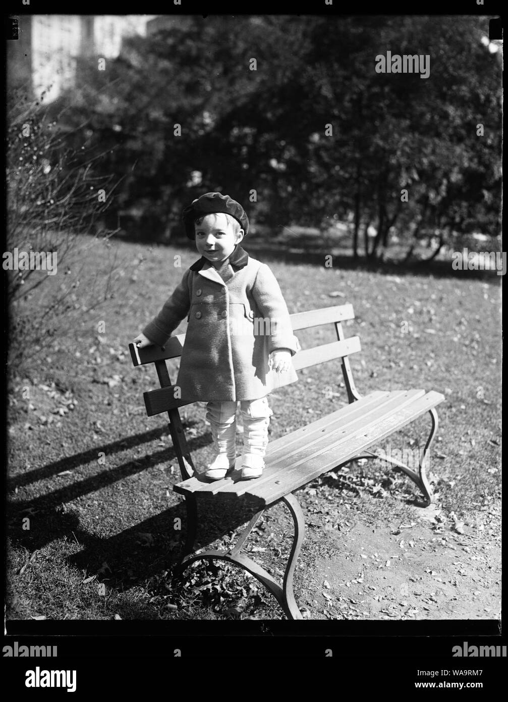 Child on park bench Stock Photo - Alamy