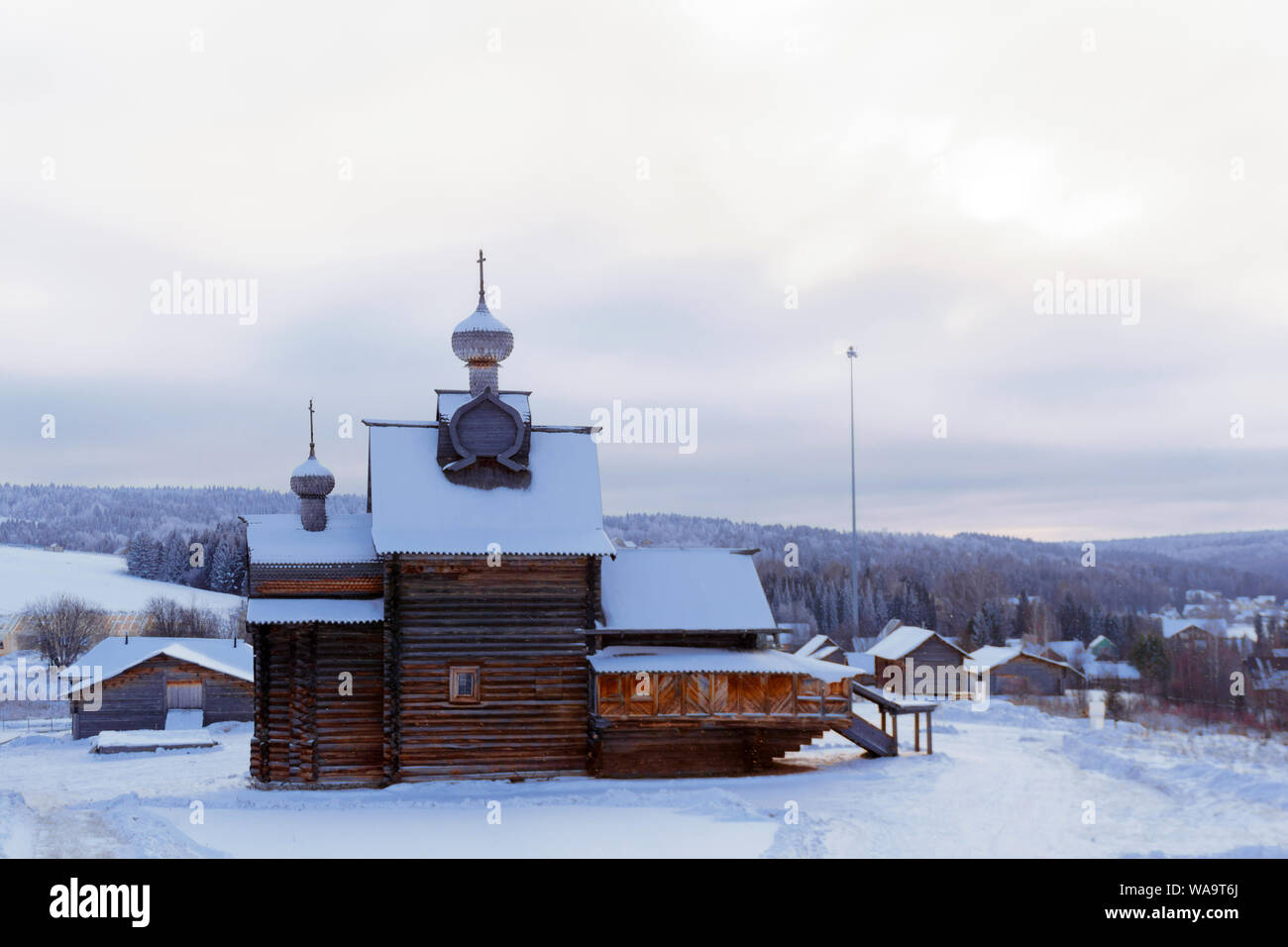 ancient russian wooden log village orthodox church in winter landscape ...