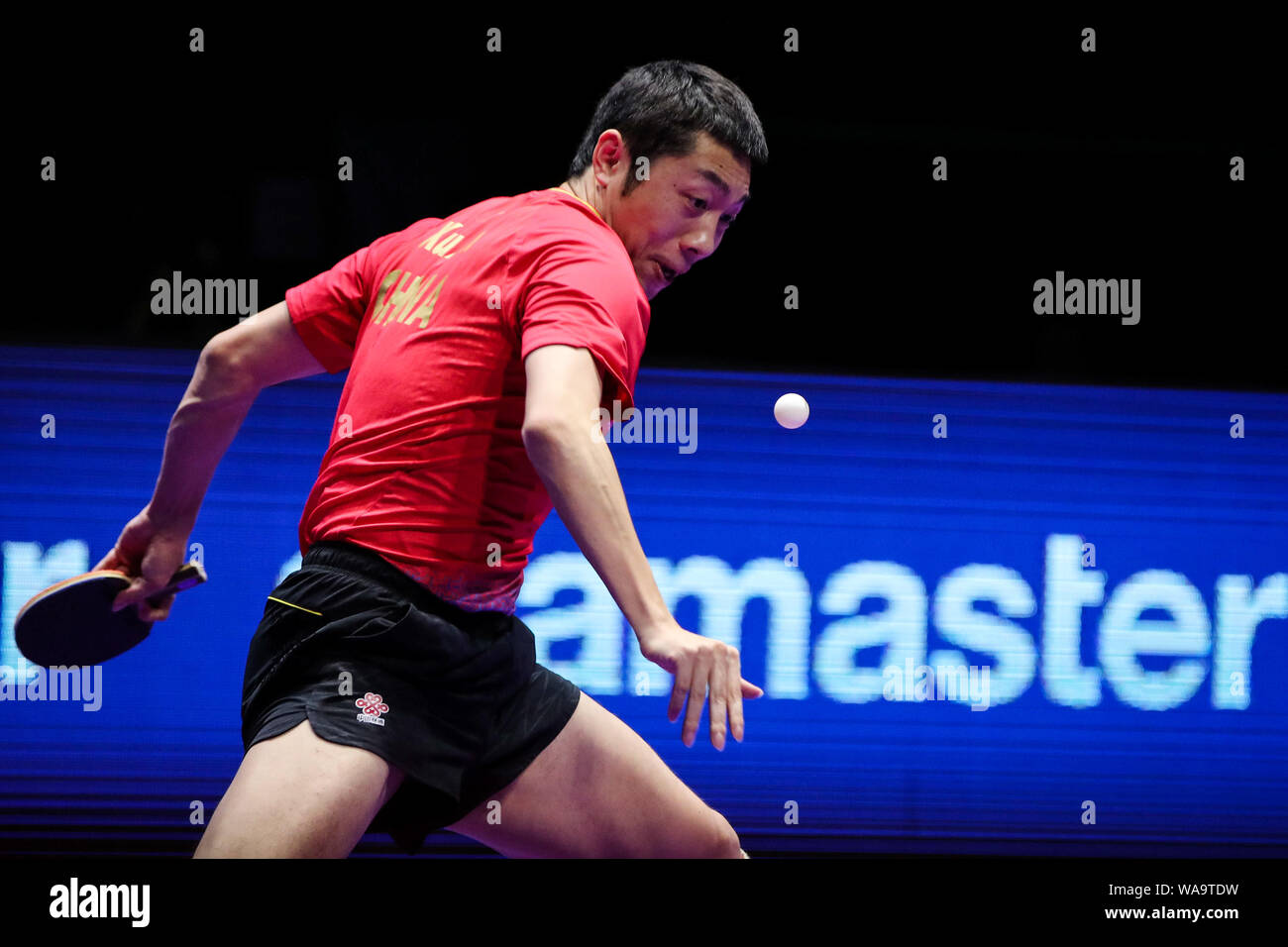 Xu Xin of China returns a shot to Ma Long of China in the final match ...