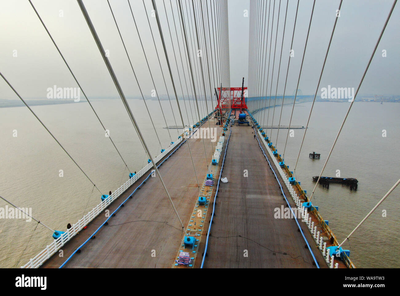 Chinese workers labor at the construction site of world's longest cable ...