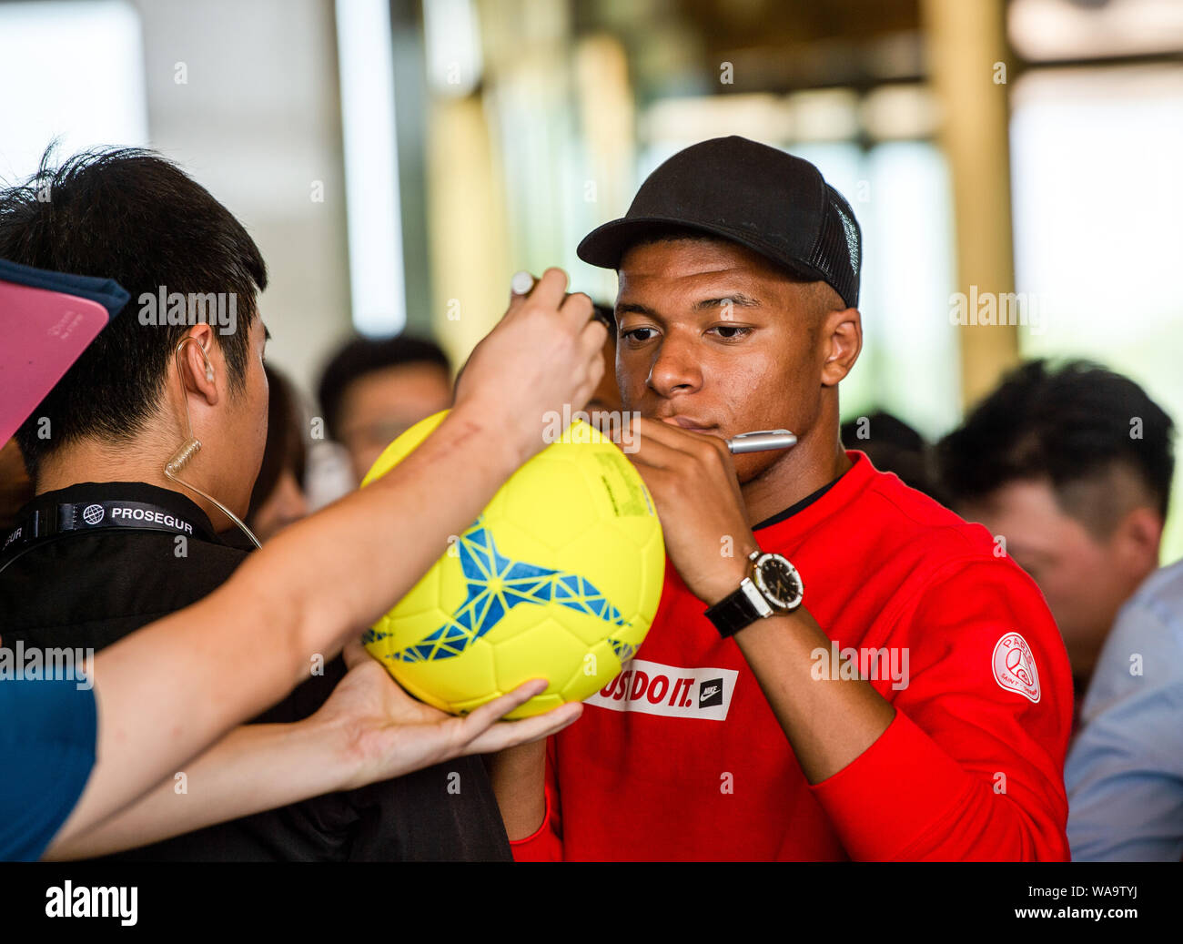 Kylian Mbappe of Paris Saint-Germain F.C. signs autographs for fans ...