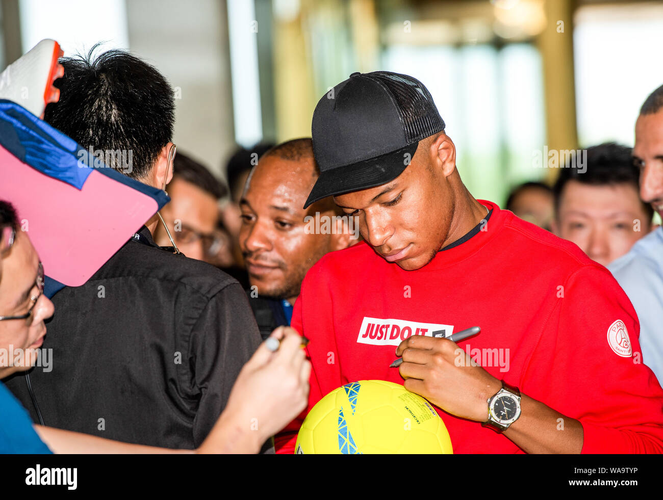Kylian Mbappe of Paris Saint-Germain F.C. signs autographs for fans ...