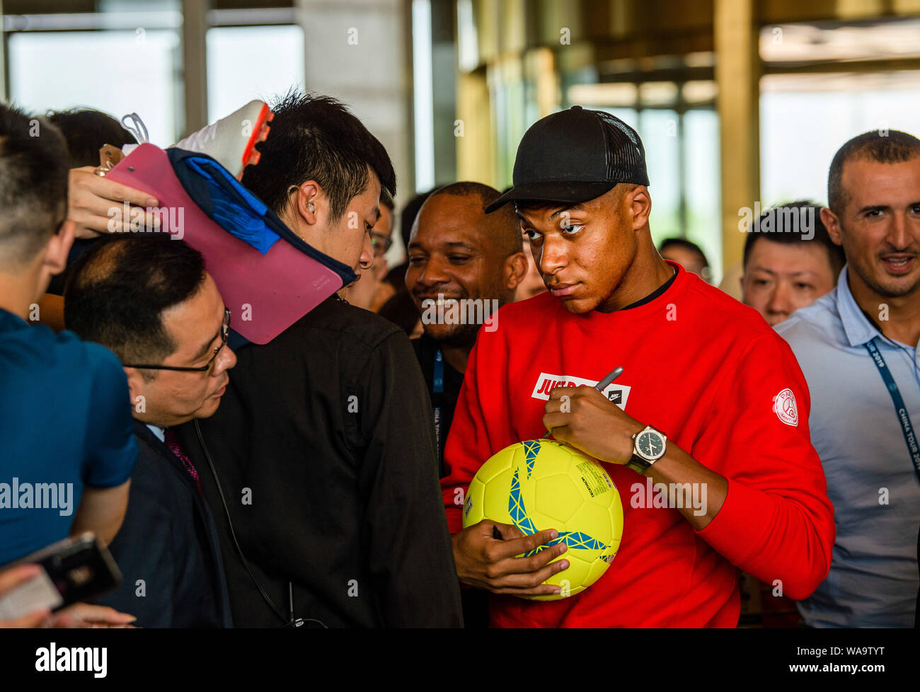 Kylian Mbappe of Paris Saint-Germain F.C. signs autographs for fans ...
