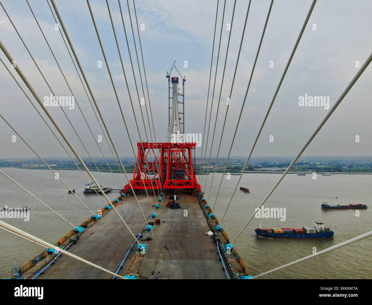 Chinese workers labor at the construction site of world's longest cable ...