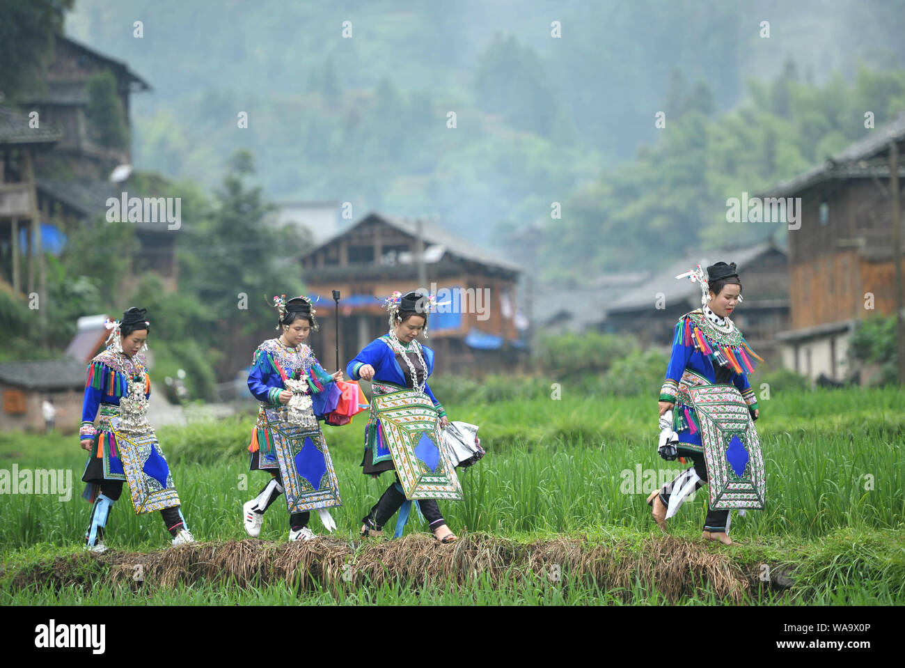 Chinese people of Dong ethnic group wearing traditional costumes and ...