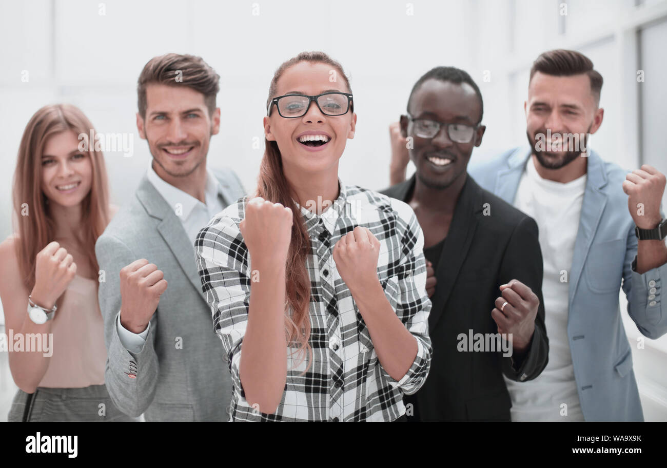 Portrait of friendly team of employees rejoicing in the office Stock ...
