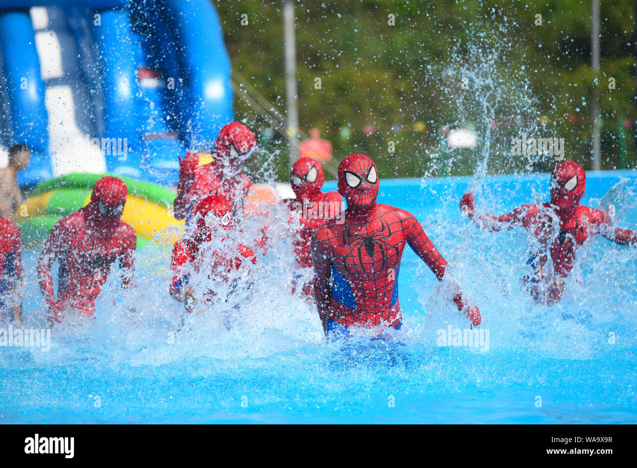 Chinese staff memers dressed as Spider-Man play in a swimming pool ...