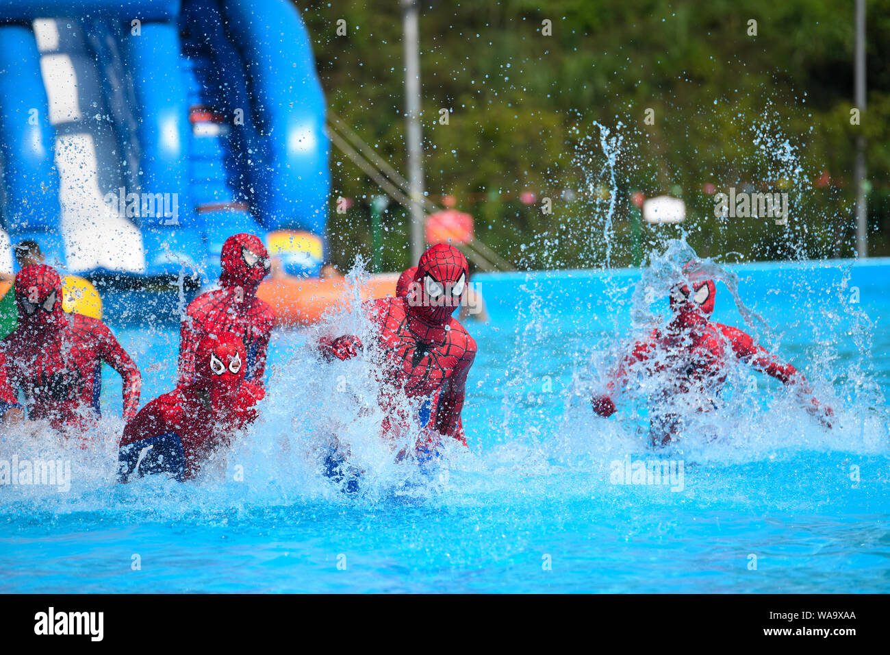 Chinese staff memers dressed as Spider-Man play in a swimming pool ...