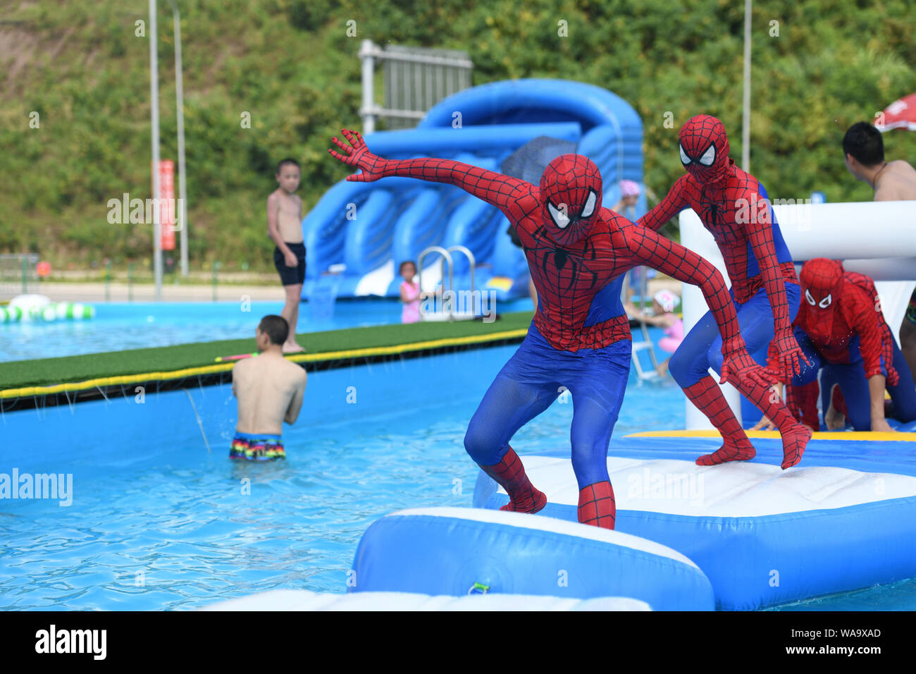 Chinese staff memers dressed as Spider-Man play in a swimming pool ...