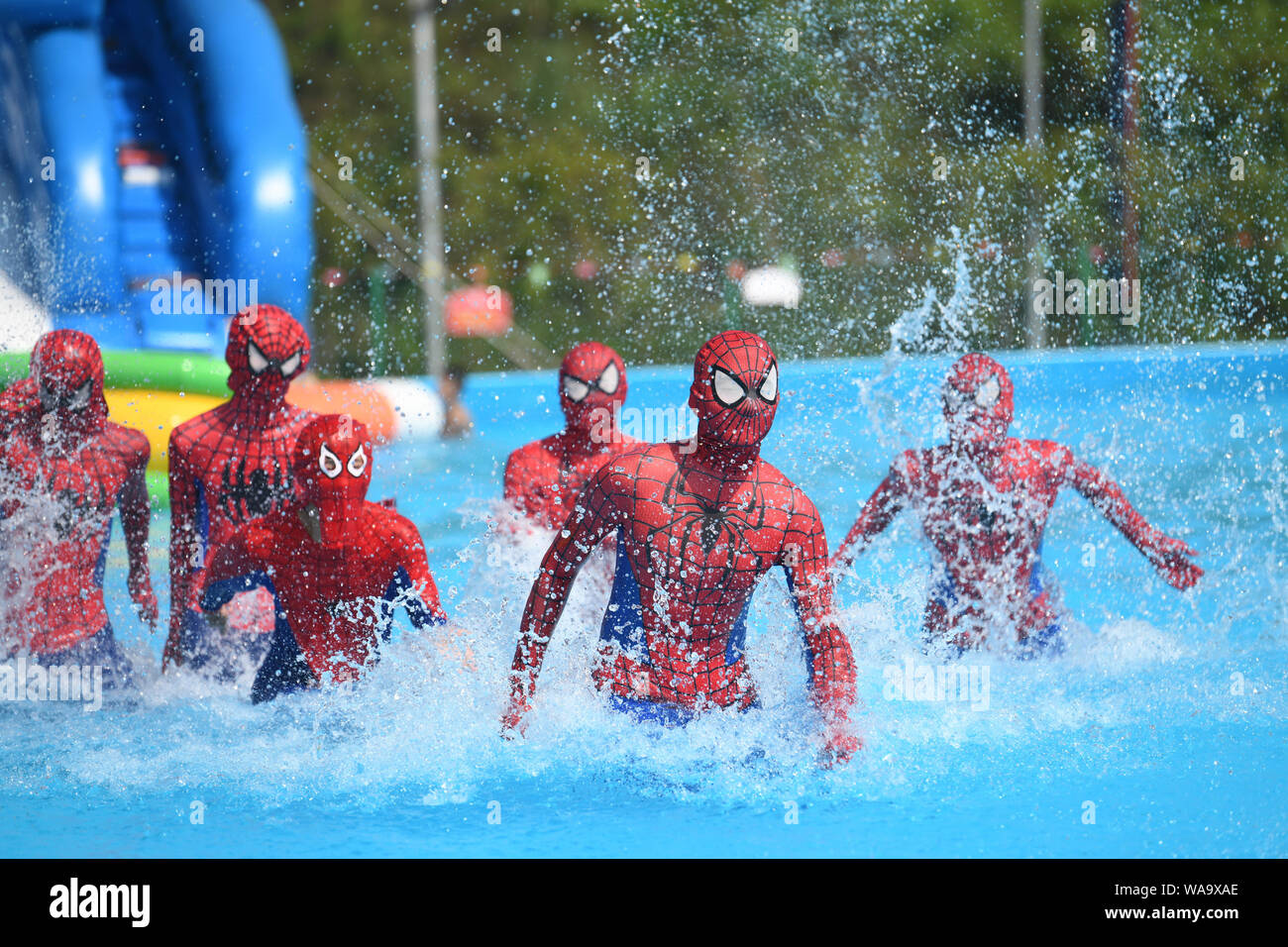 Chinese staff memers dressed as Spider-Man play in a swimming pool ...