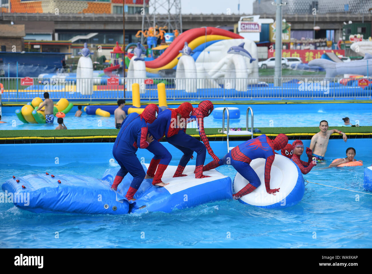 Chinese staff memers dressed as Spider-Man play in a swimming pool ...