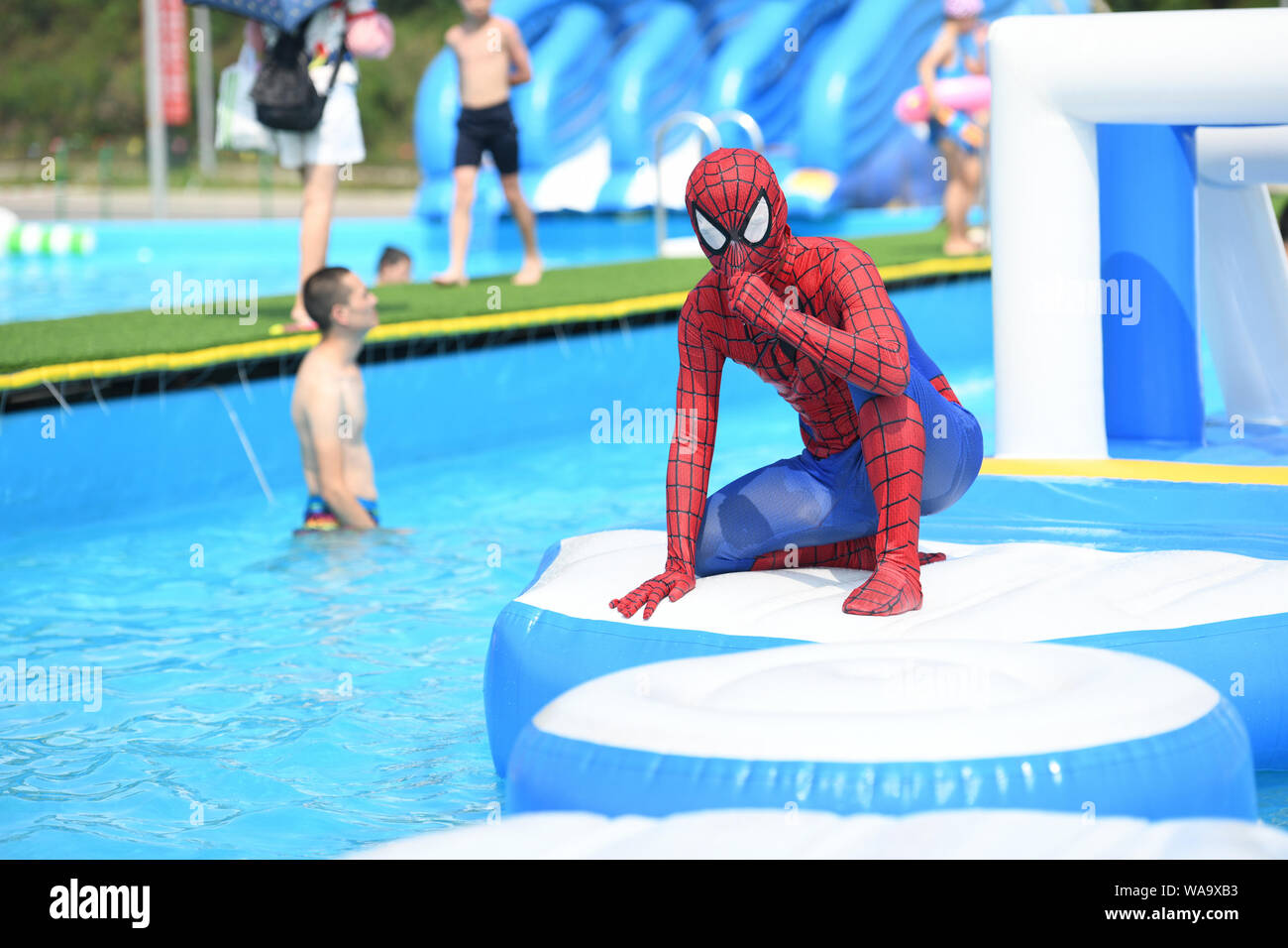 Chinese staff memers dressed as Spider-Man play in a swimming pool ...