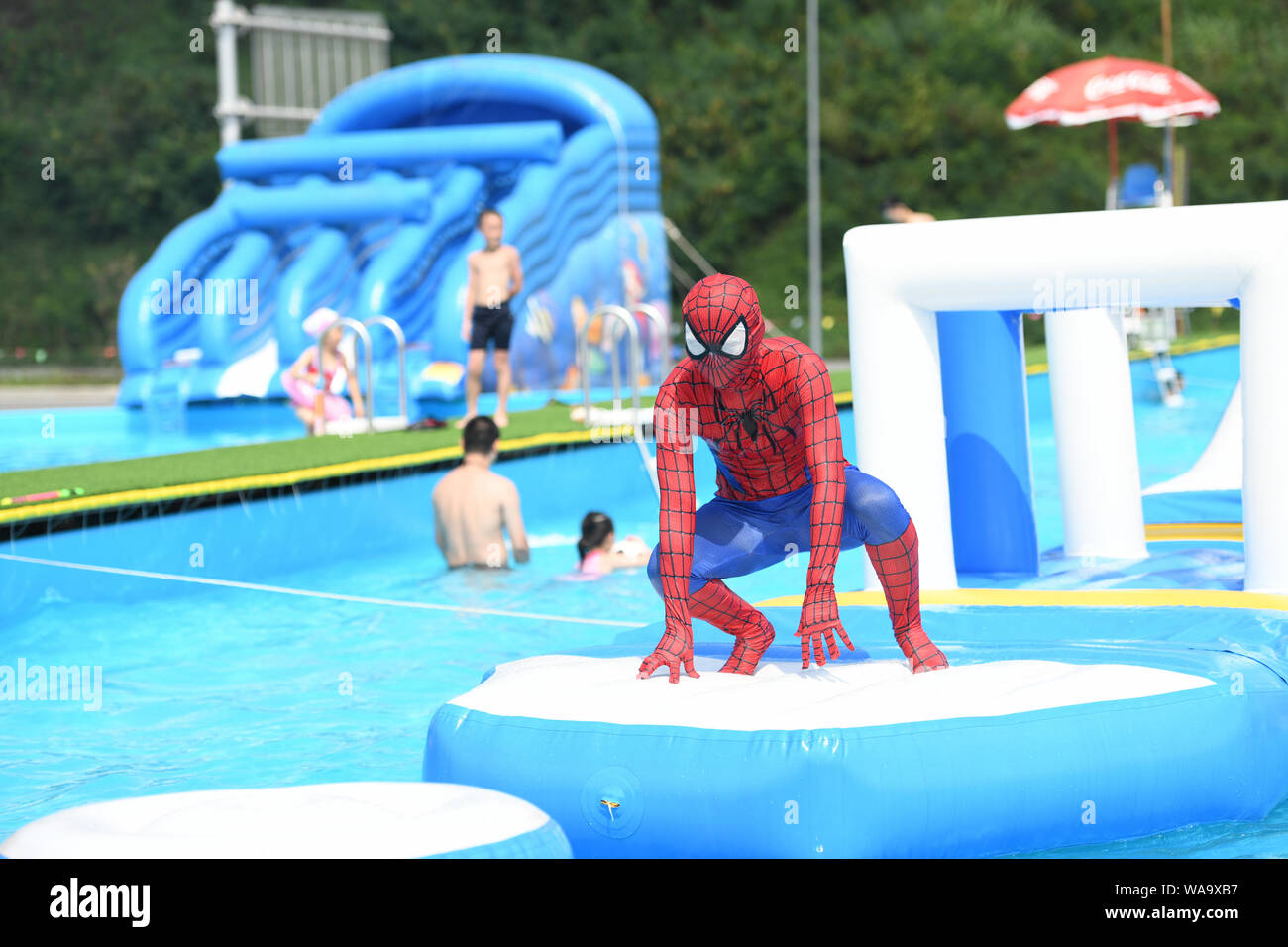 Chinese staff memers dressed as Spider-Man play in a swimming pool ...