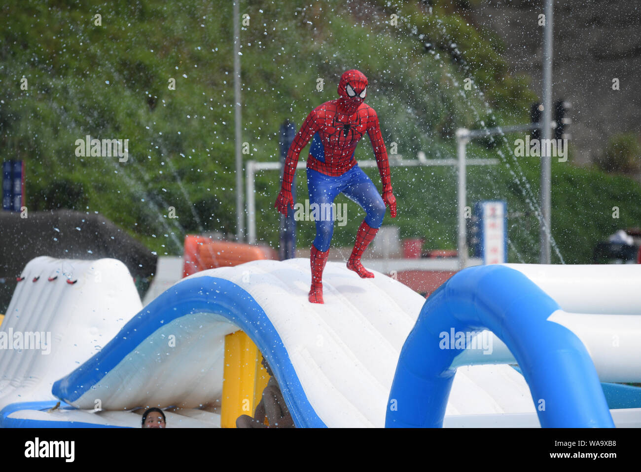 Chinese staff memers dressed as Spider-Man play in a swimming pool ...
