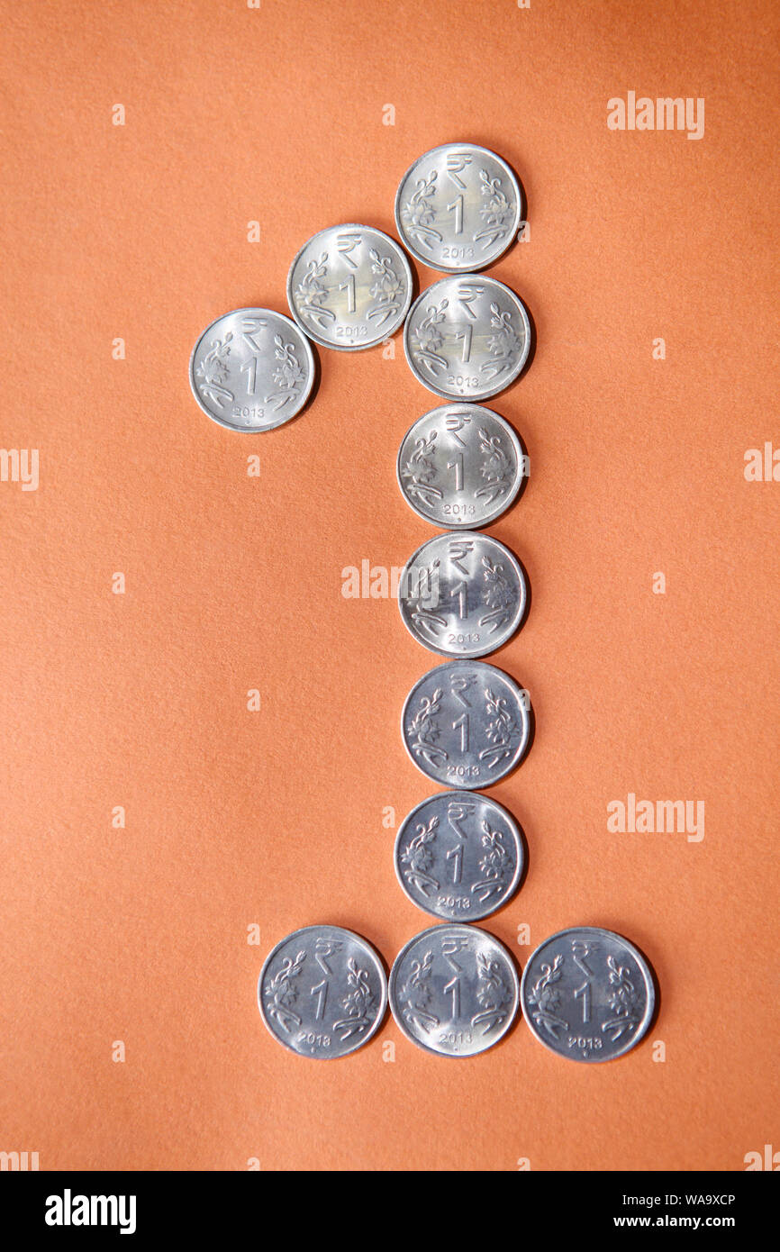 Indian one rupee coins representation number one Stock Photo - Alamy