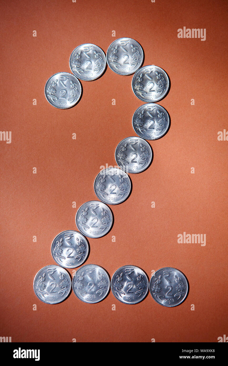 Indian two rupee coins representing number two Stock Photo - Alamy
