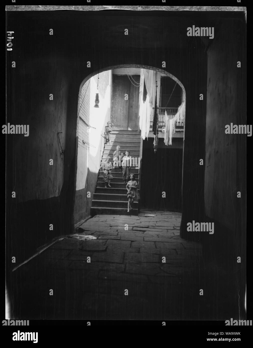 Children sitting on steps in a courtyard, New Orleans Stock Photo - Alamy
