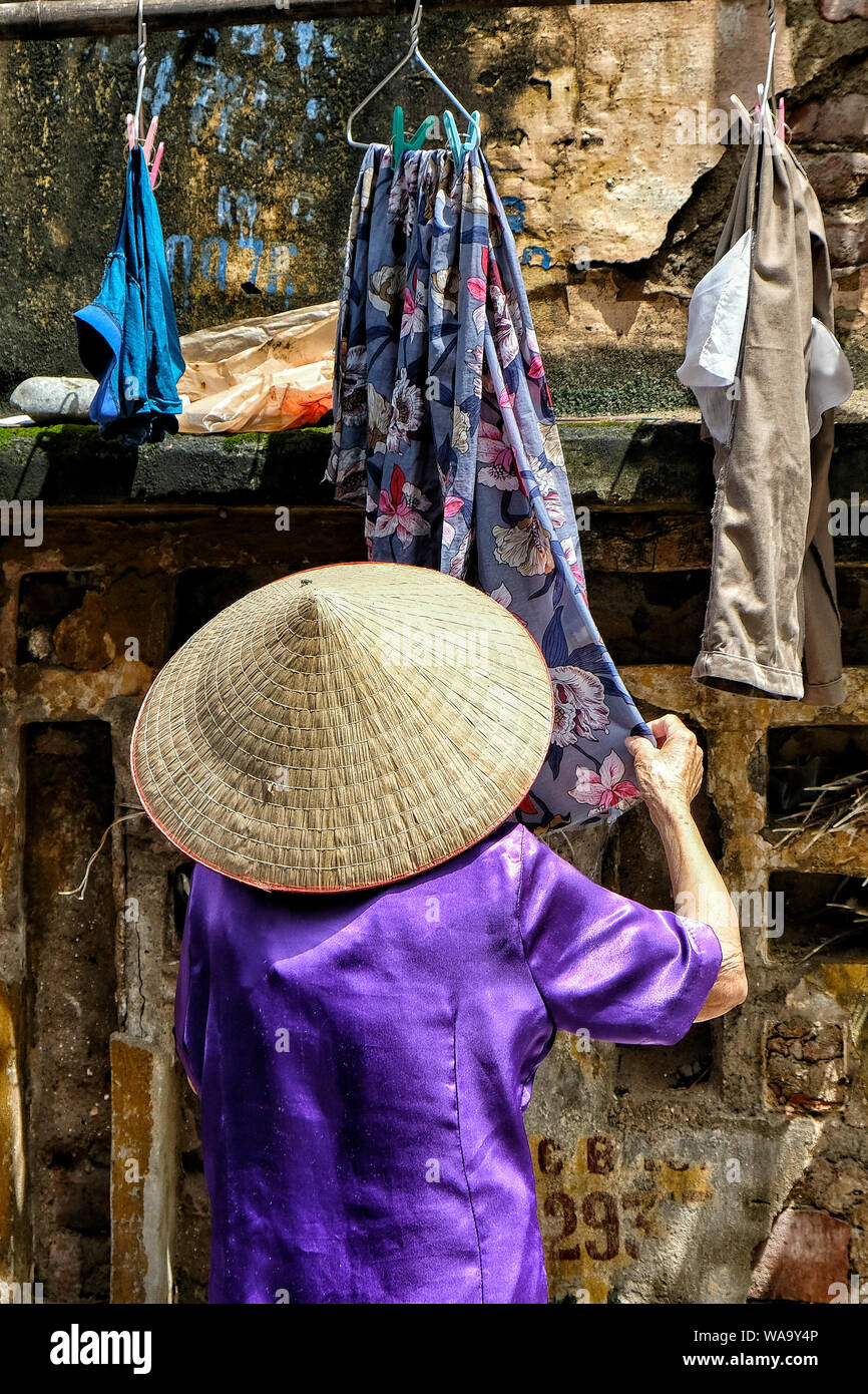 Woman tending clothes on a street in Hanoi, Vietnam Stock Photo - Alamy