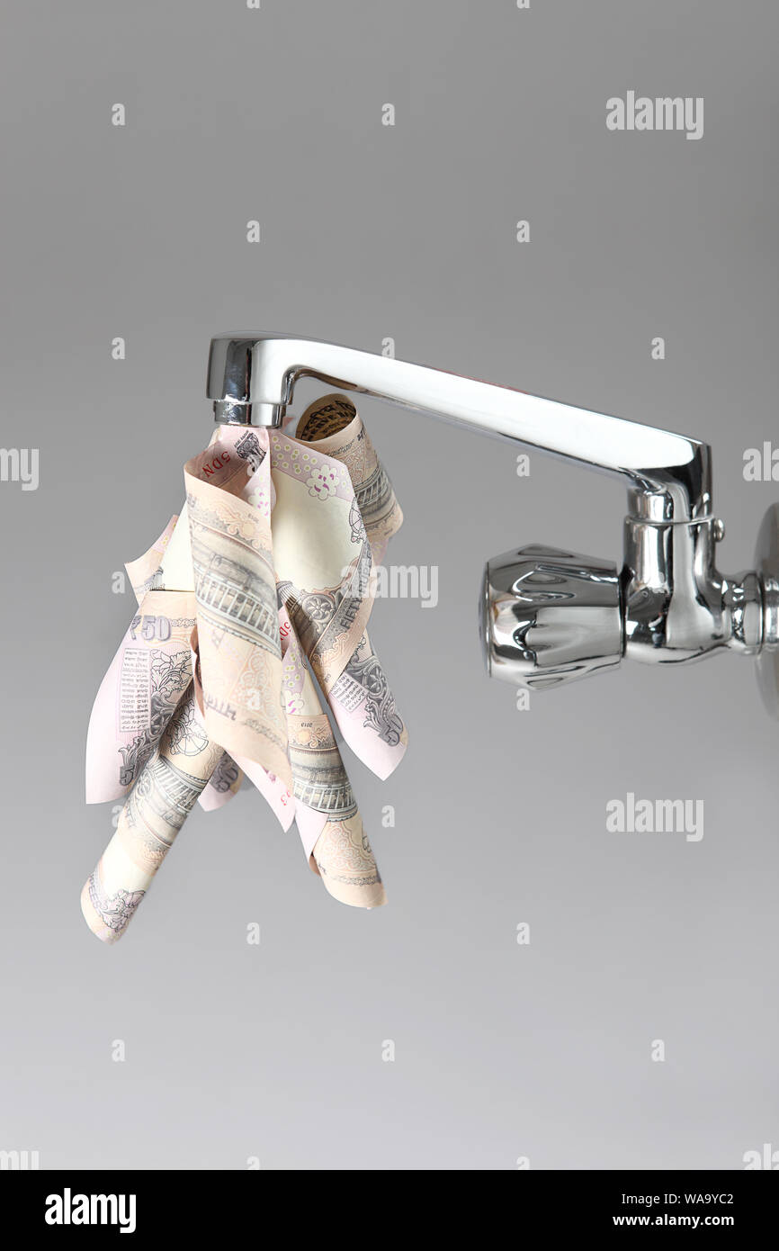 Indian fifty rupee notes Pouring Out of Water Tap Stock Photo - Alamy