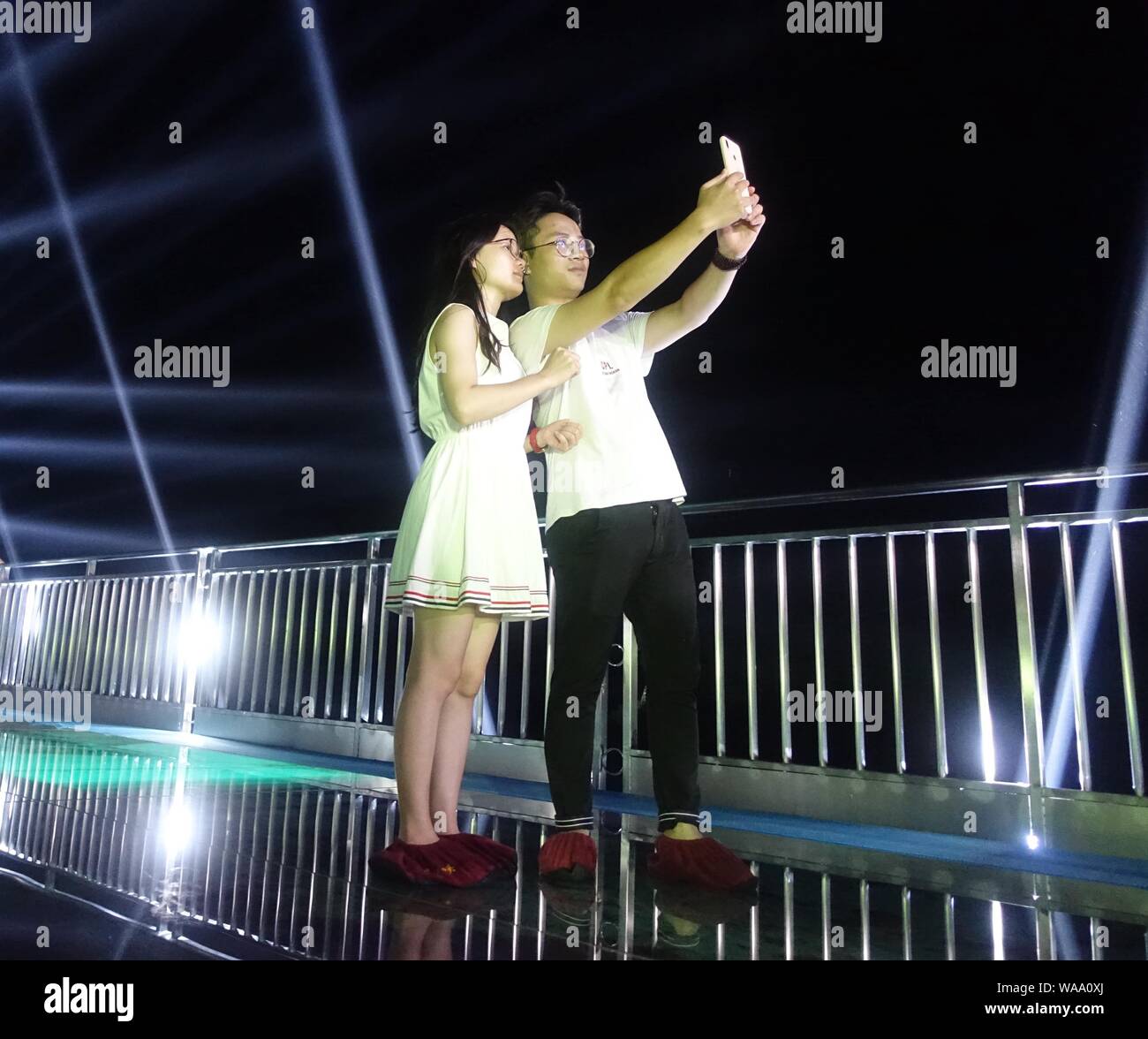 Tourists take selfies on Guangdong's highest circular glass bridge at ...