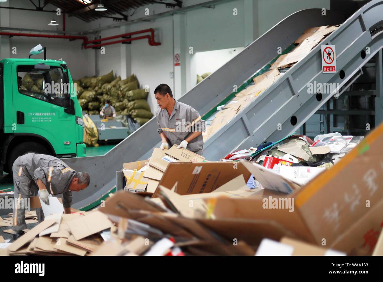 A Chinese worker sorts out recycling waste at a distribution center of ...