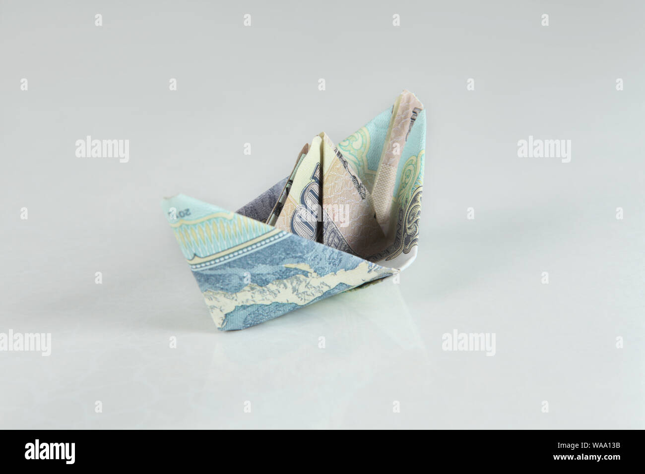 Paper boat of one hundred rupee note on white background Stock Photo ...