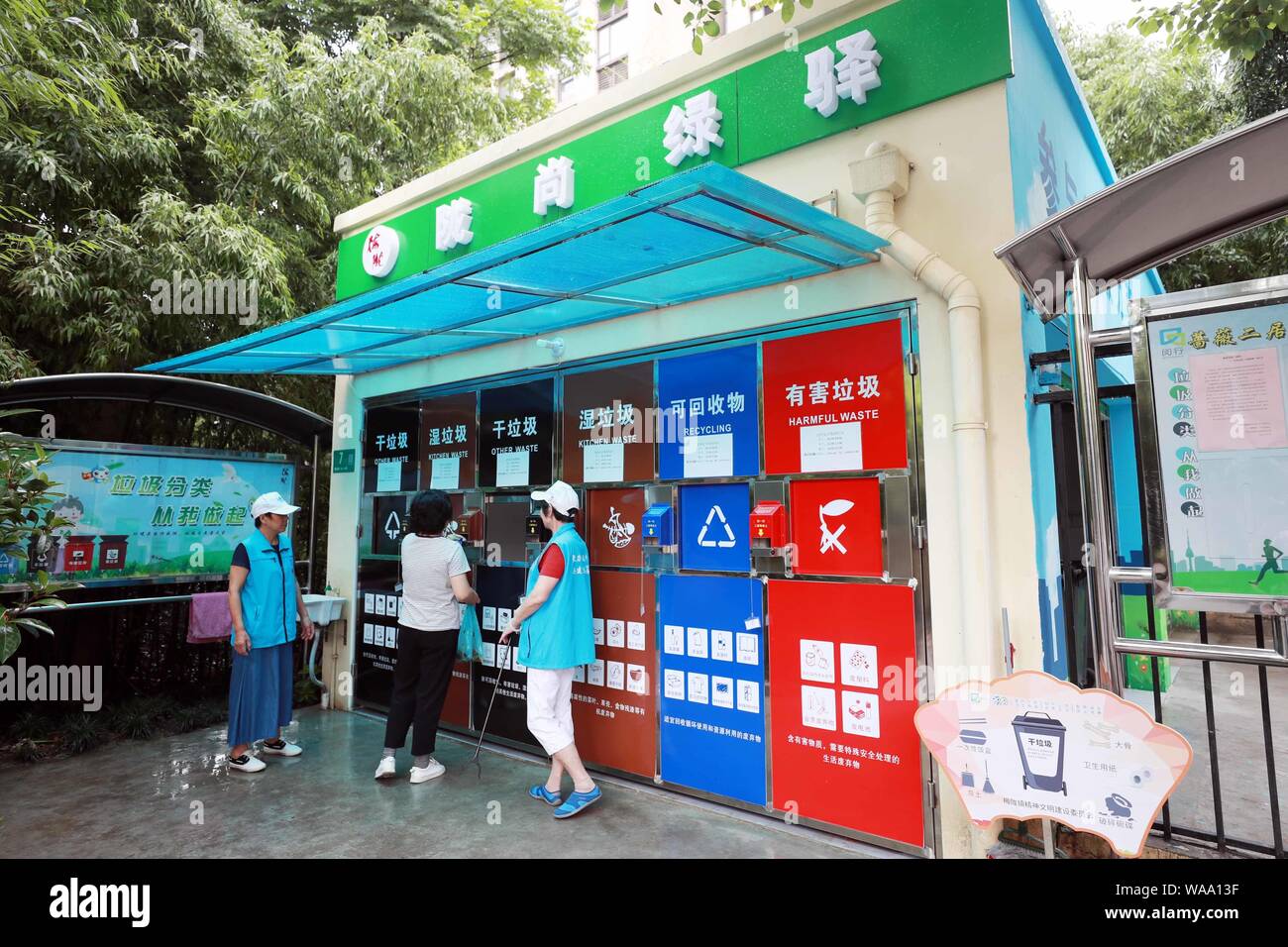 A local resident throws rubbish into different bins deployed to meet ...