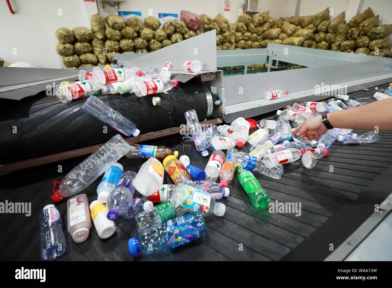 A Chinese worker sorts out recycling waste at a distribution center of ...