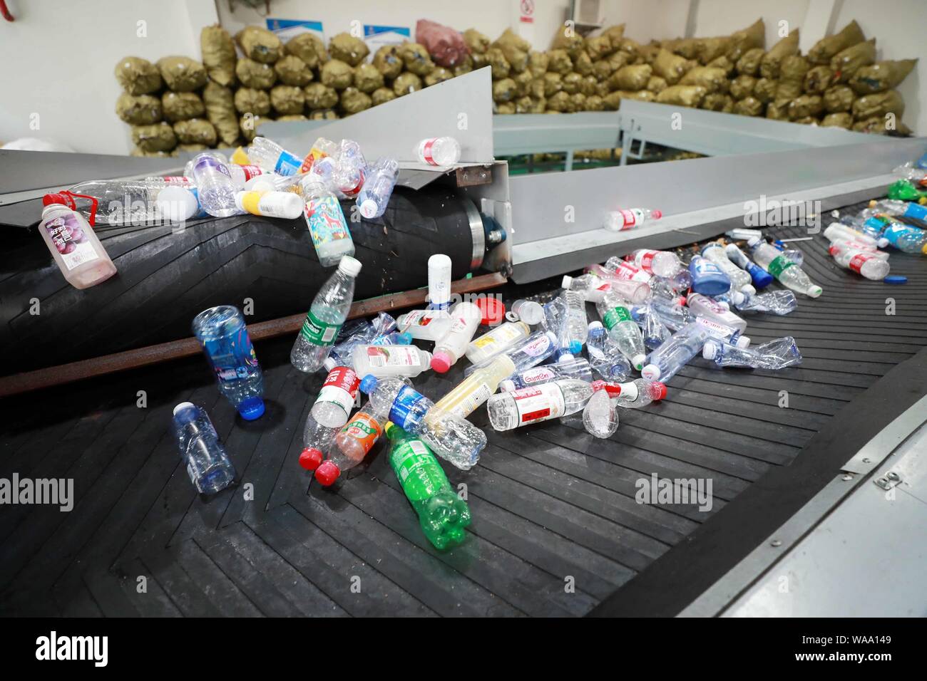 A Chinese worker sorts out recycling waste at a distribution center of ...