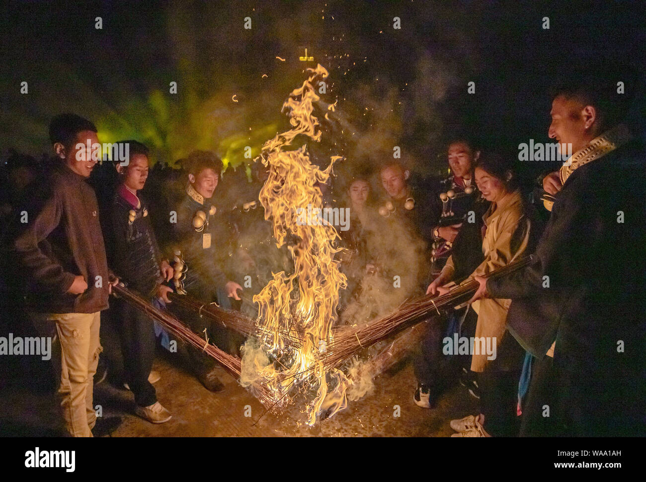 Chinese people of Yi ethnic group gather at a bonfire party to mark the traditional Torch ...