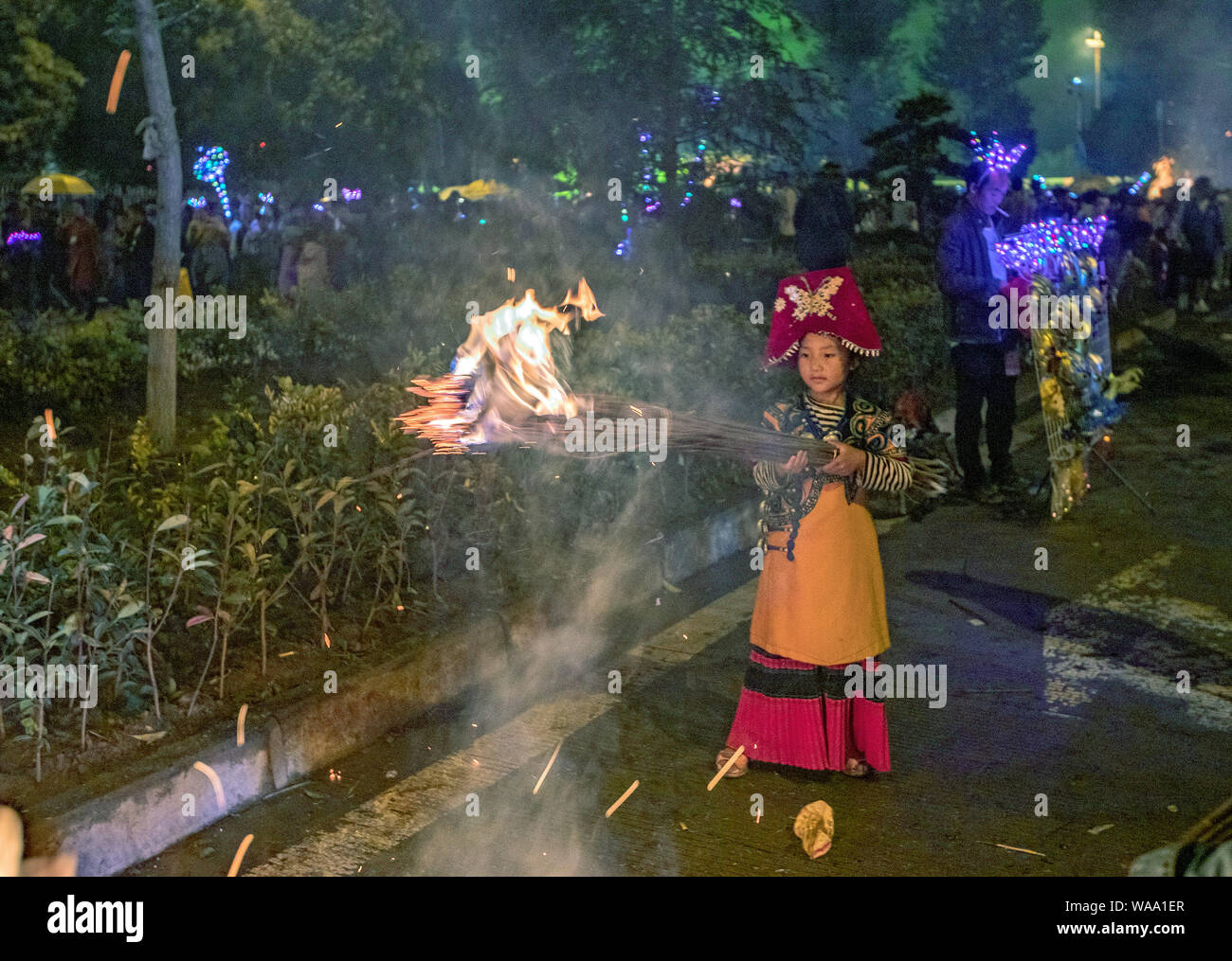 Chinese people of Yi ethnic group gather at a bonfire party to mark the traditional Torch ...