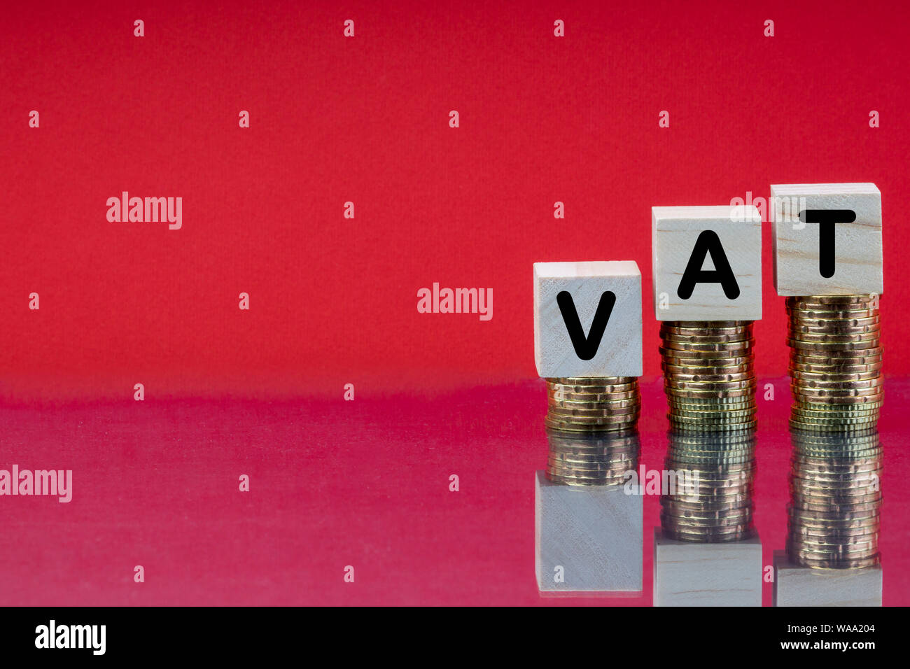 VAT or TAX Concept with wooden block on stacked coins and red ...