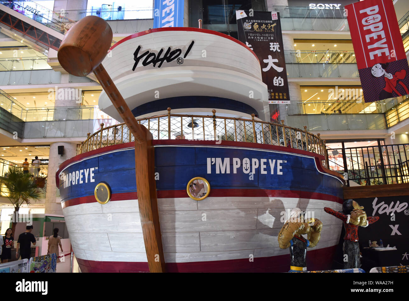 Customers view sculptures featuring cartoon character "Popeye the ...