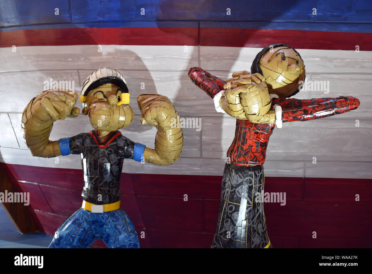 Customers view sculptures featuring cartoon character "Popeye the ...