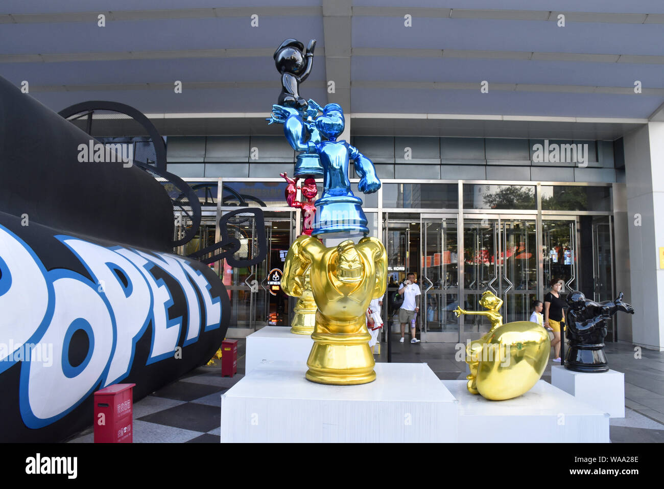 Customers view sculptures featuring cartoon character "Popeye the ...