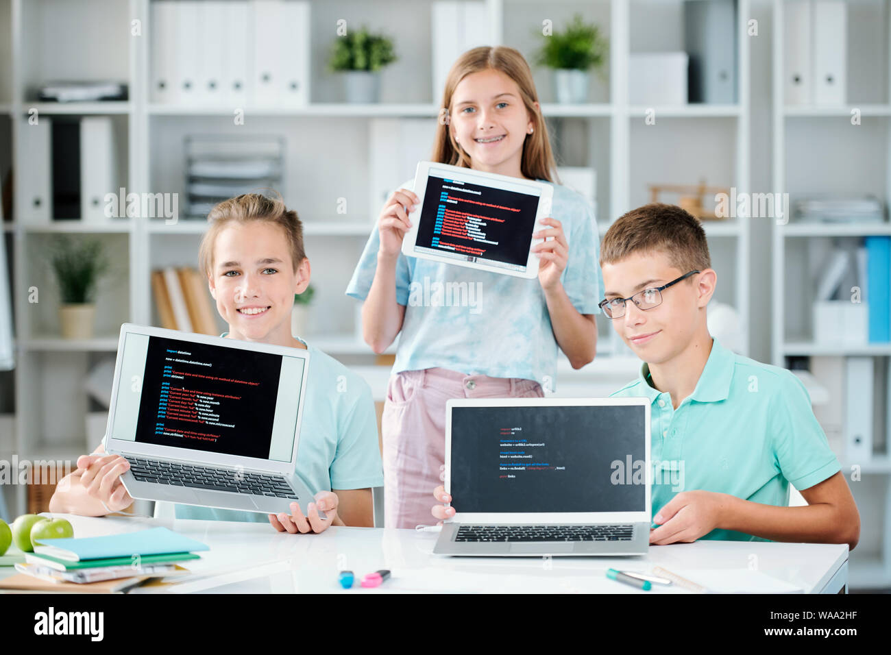 Three happy successful classmates hi-res stock photography and images ...