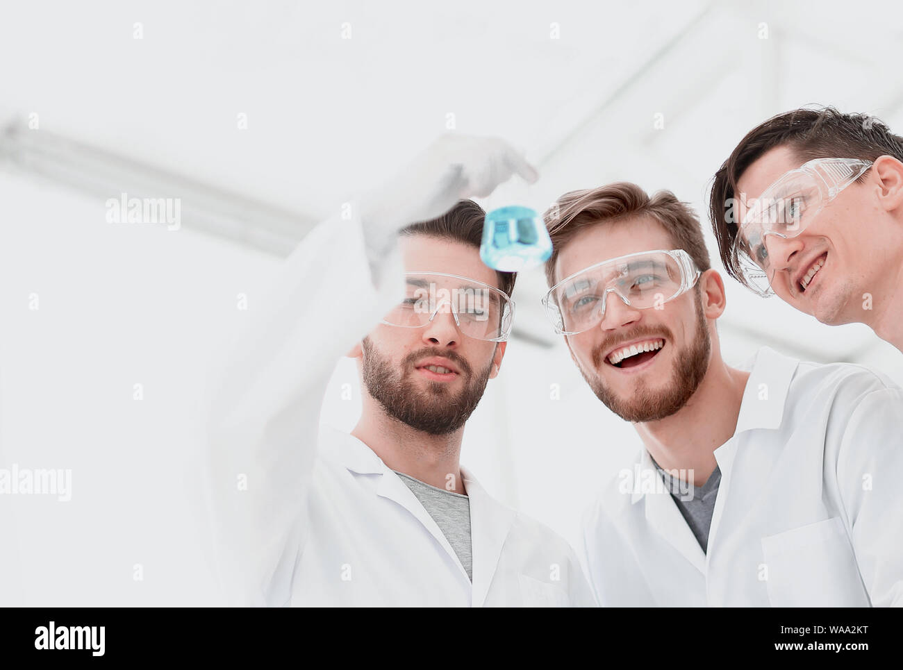 happy scientists look at the result of their work Stock Photo - Alamy