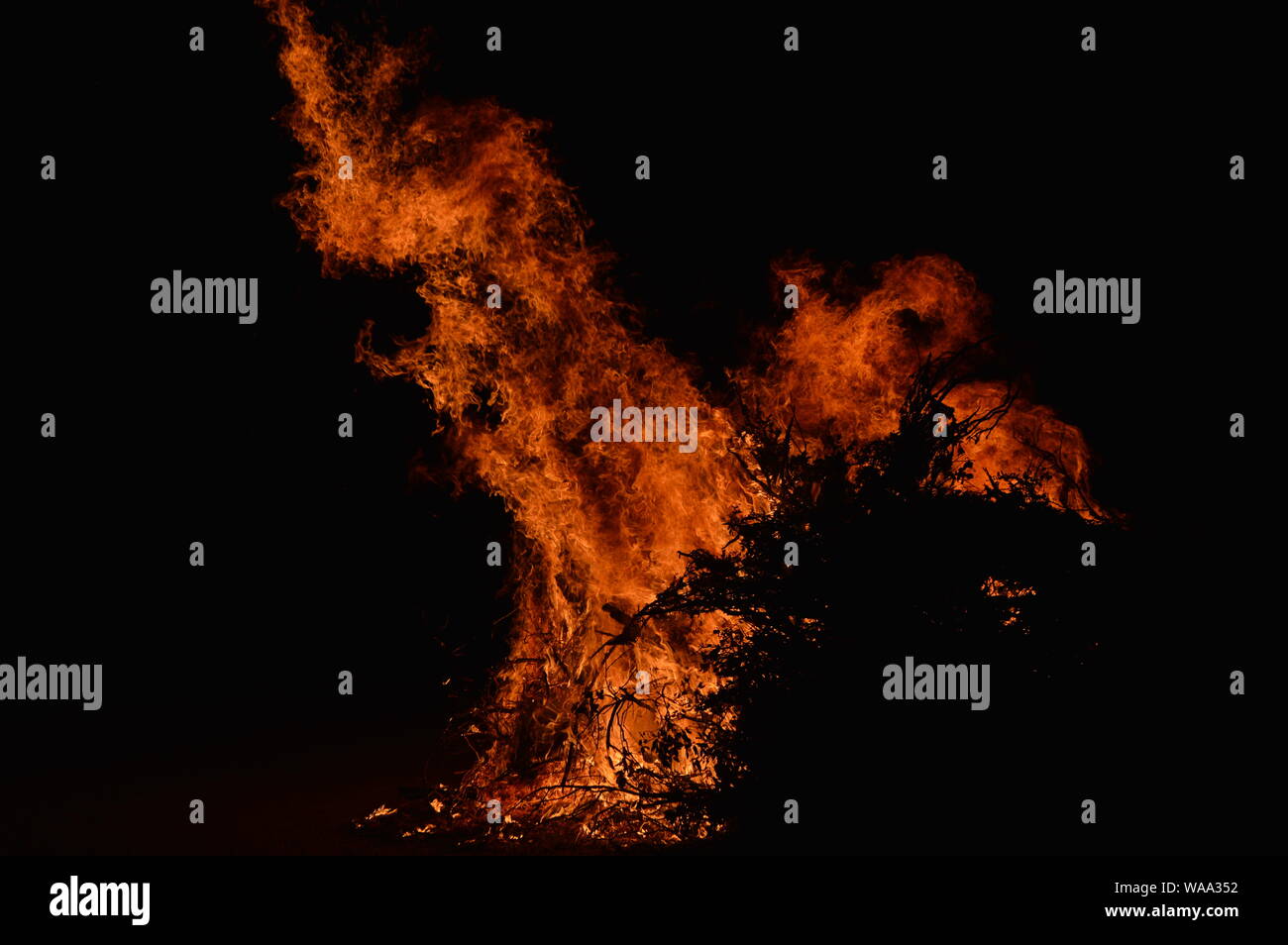 Flames in the night Stock Photo - Alamy