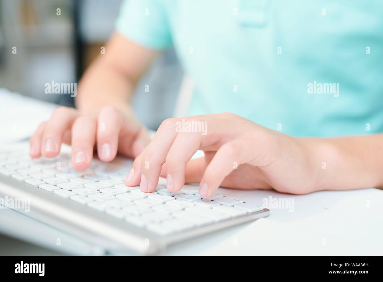 Human hands pushing keys of computer keyboard while sitting by desk ...