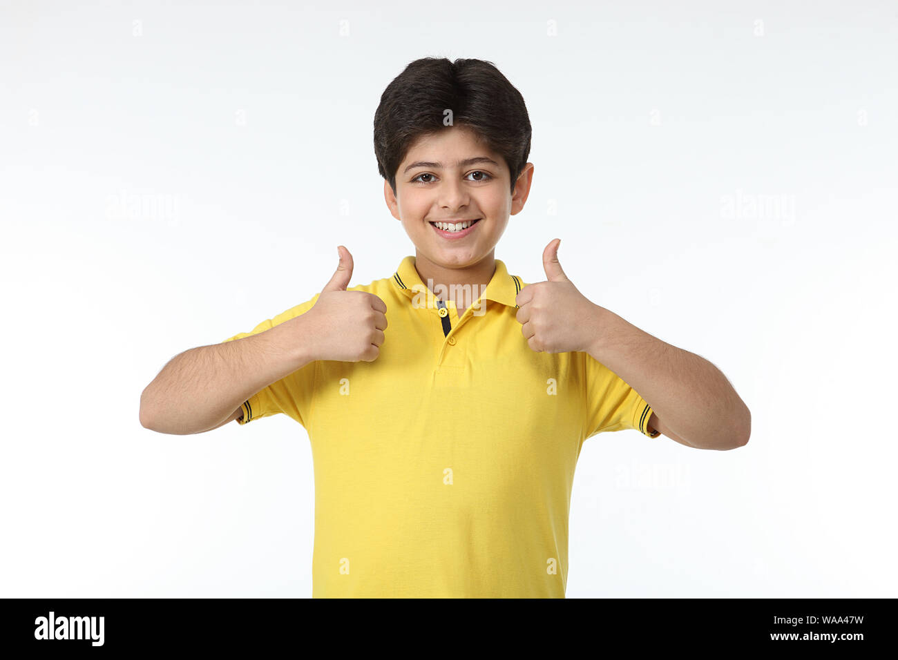 Boy smiling and showing thumbs up sign Stock Photo - Alamy