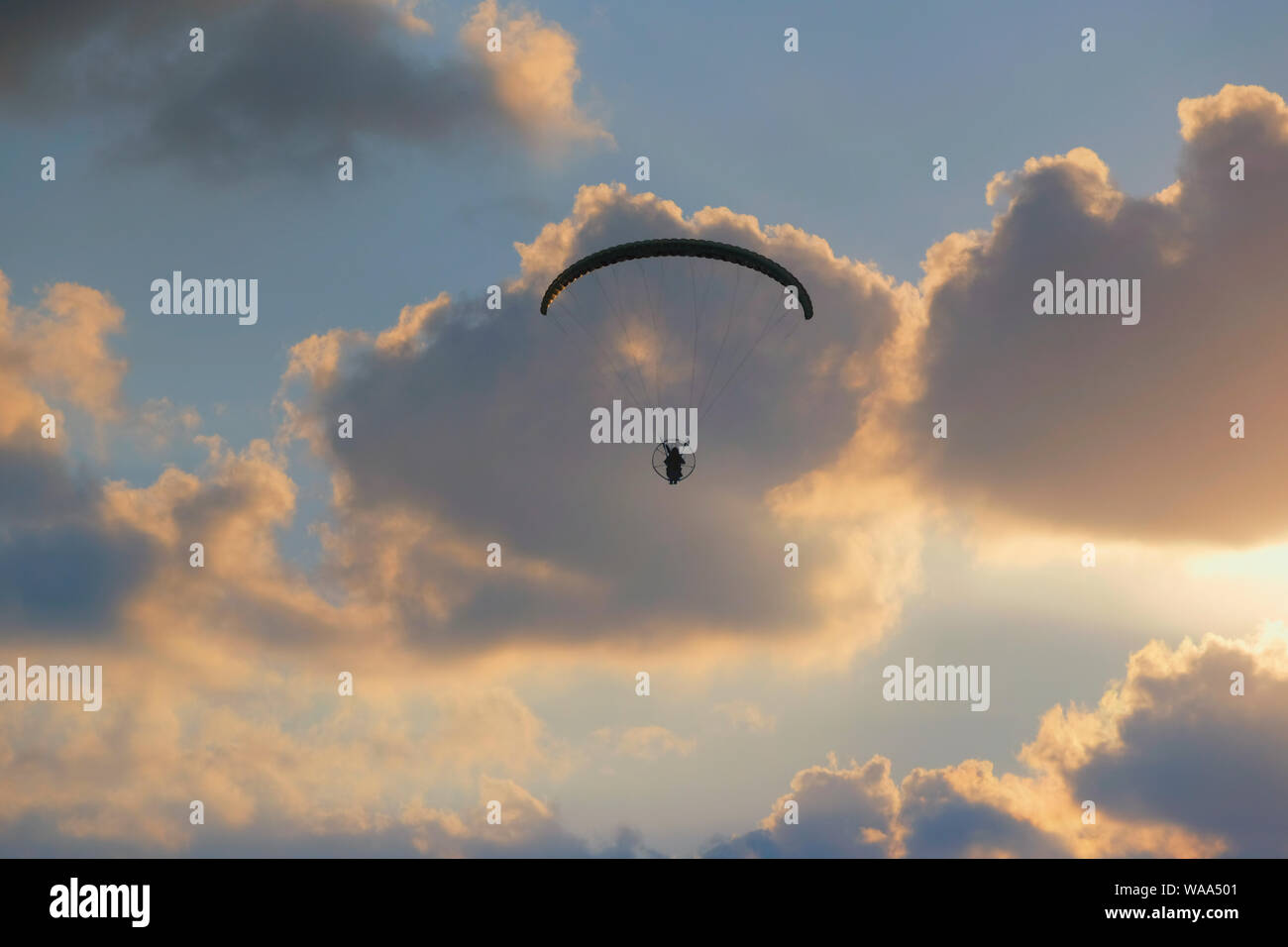 A powered paraglider in flight Stock Photo - Alamy