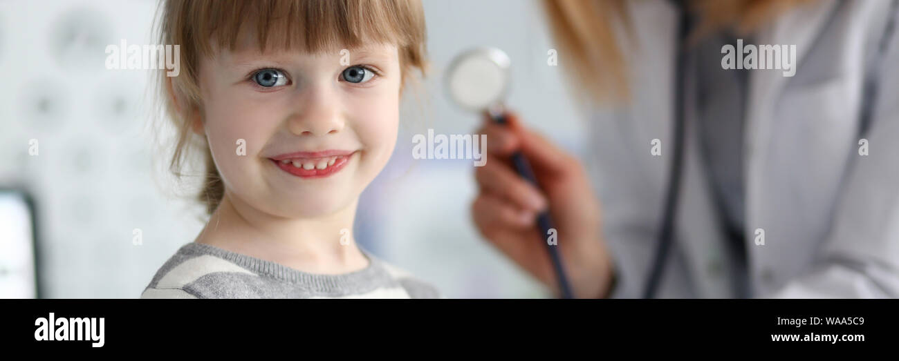 Smiling cute little patient interacting with female doctor Stock Photo ...